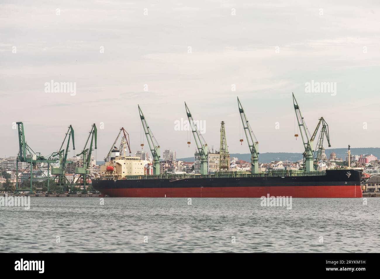 Varna, Black Sea port seaside view with moored bulk carrier ship ...