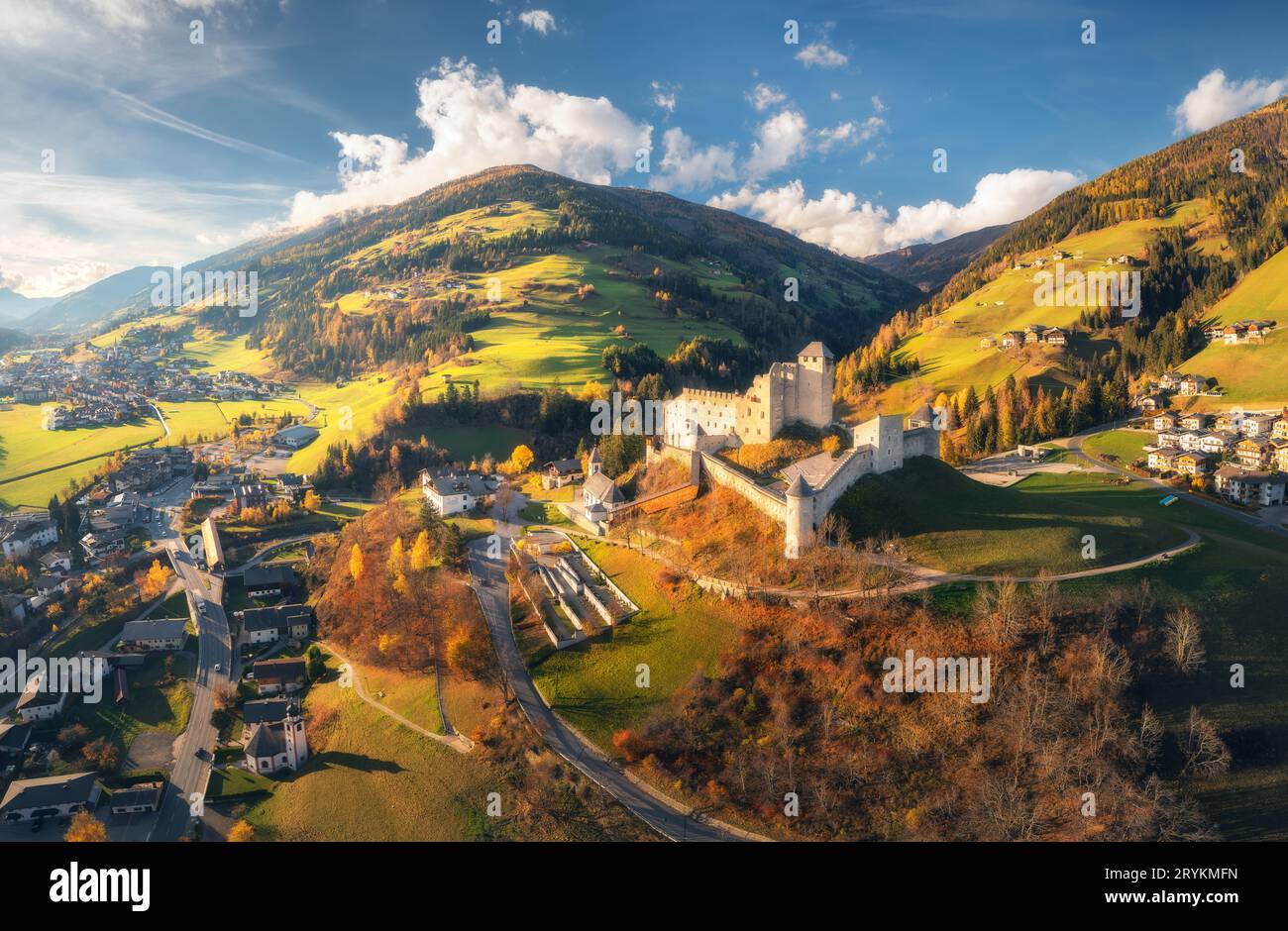 Aerial view of beautiful medieval castle, green alpine meadows Stock ...