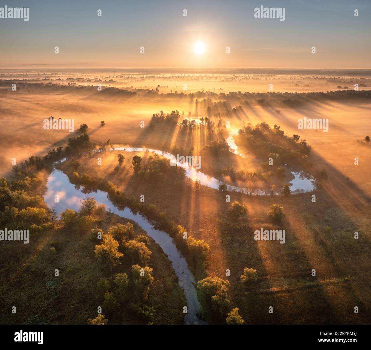 Aerial view of beautiful curving river in low clouds at sunrise Stock ...
