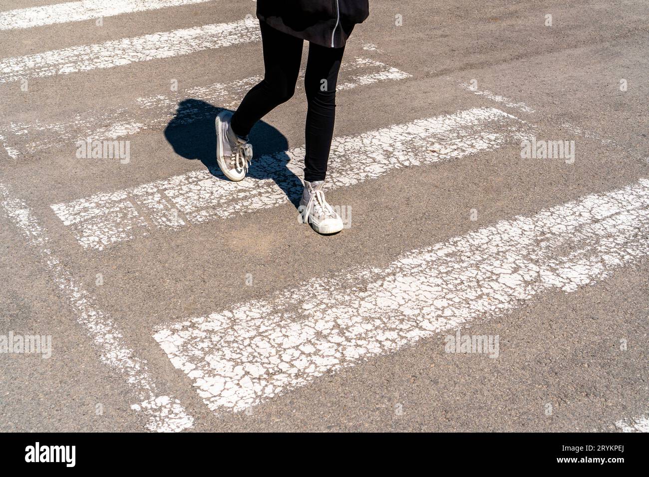Girl feet crossing the crosswalk Stock Photo - Alamy