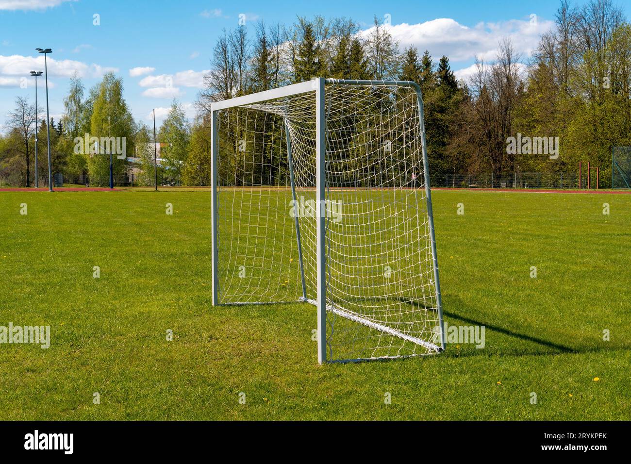 Sports field with mini goal and net on meadow Stock Photo - Alamy