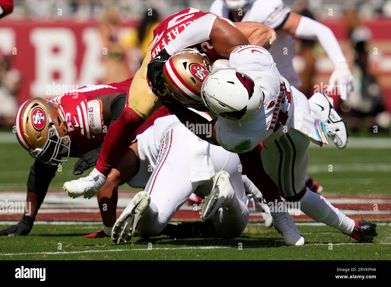 San Francisco 49ers running back Christian McCaffrey, top left, is tackled by Arizona Cardinals ...