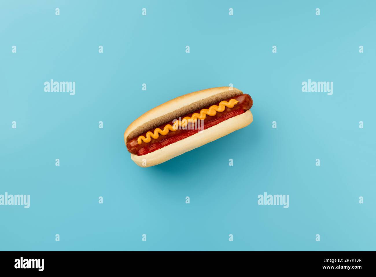 Classic hot dog with wurst, ketchup and mustard on blue background ...