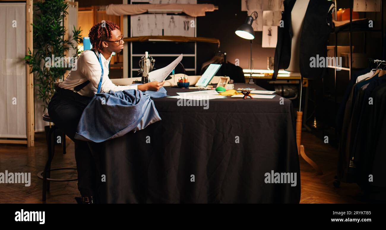 Seamstress using sewing machine to design and craft fashion items at ...