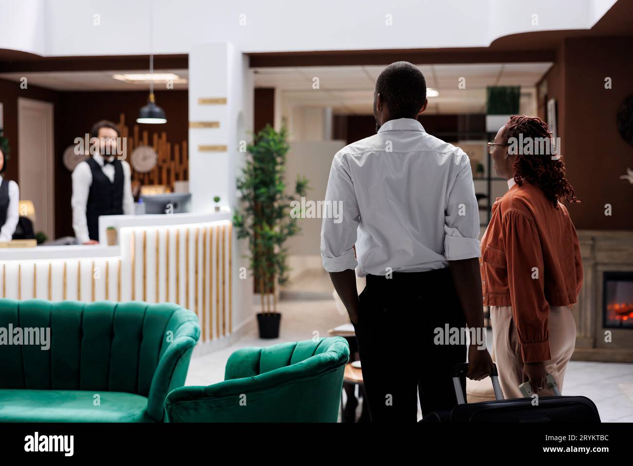 People arriving at luxury hotel lobby, entering lounge area and ...