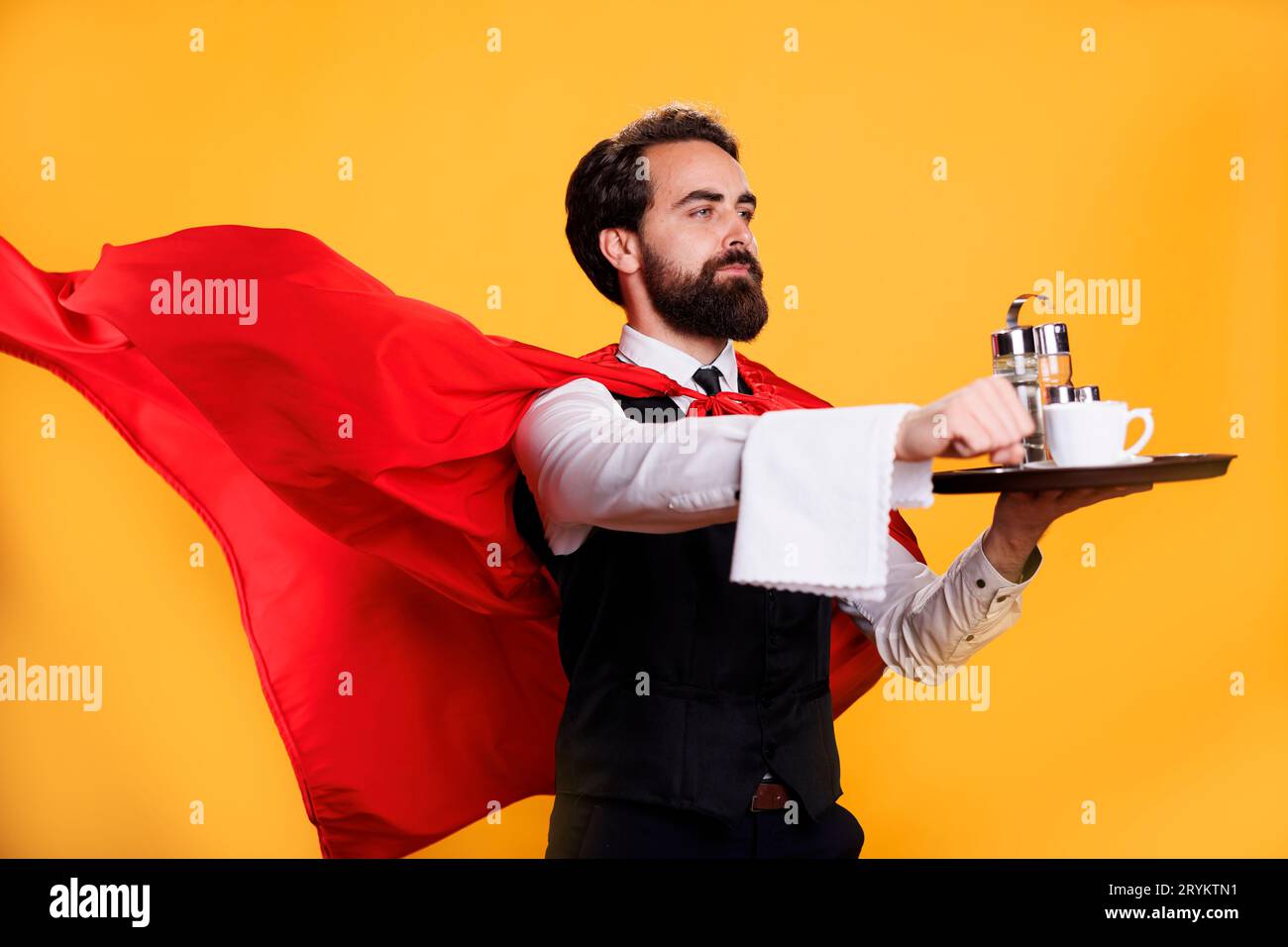 Elegant butler carry plate to serve dinner, wearing red superhero cape ...