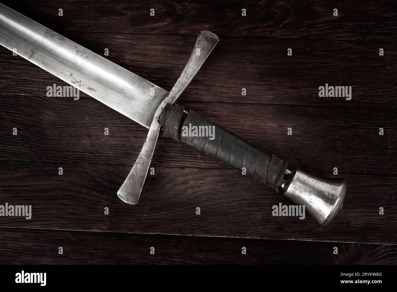 Medieval vintage sword on wooden background Stock Photo - Alamy