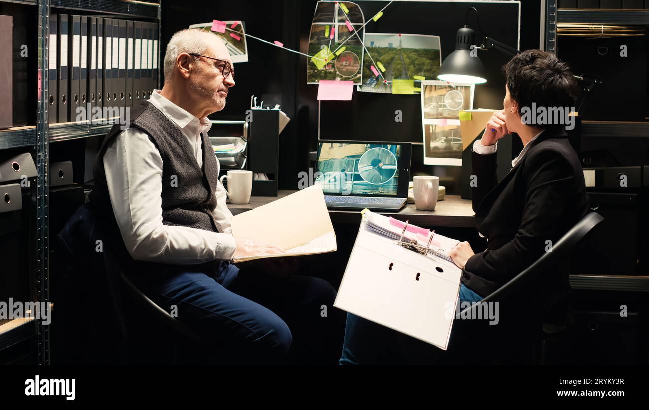 Law agents gathering intelligence and reviewing incriminating proof to ...