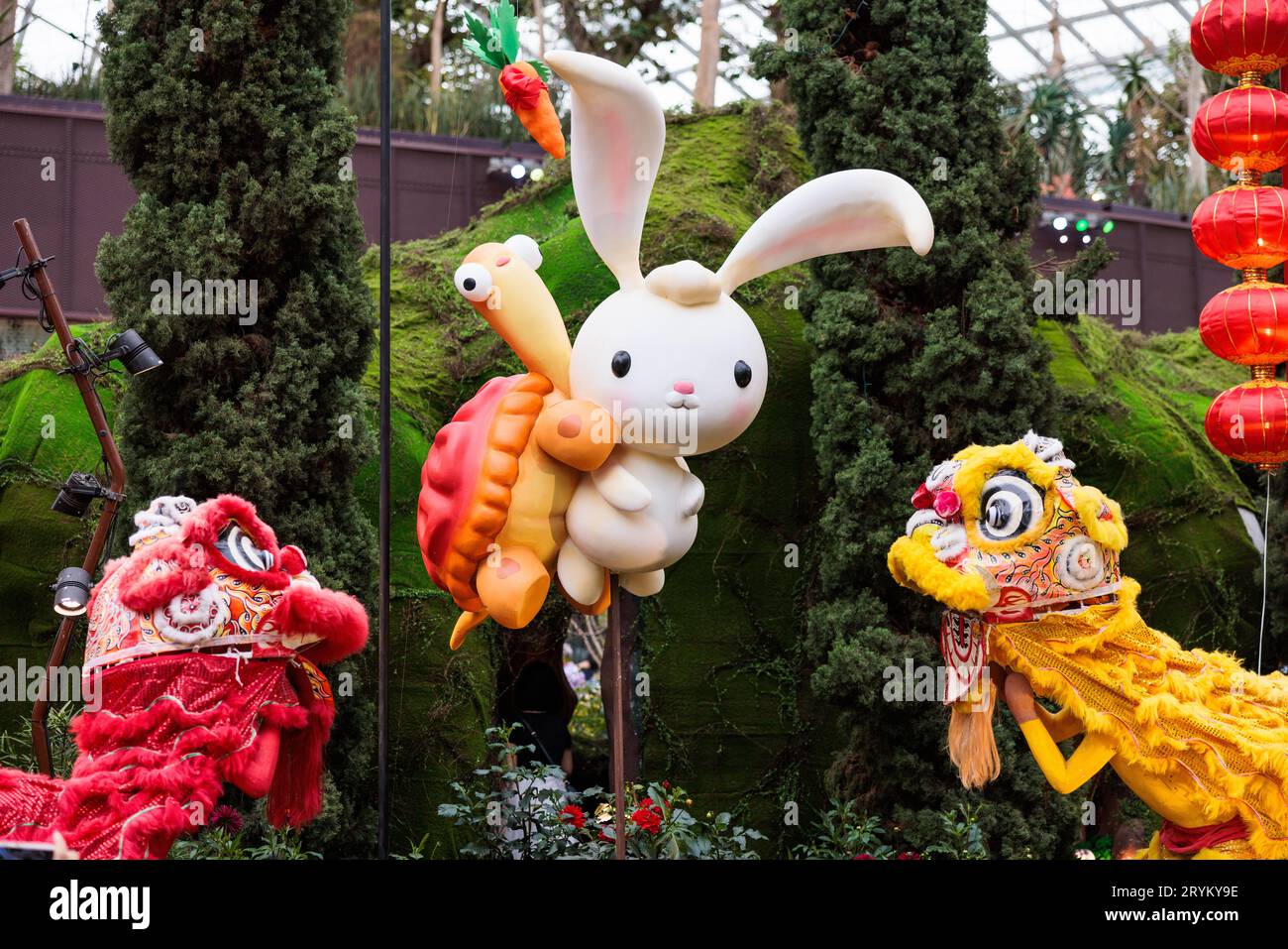 Cute and adorable cartoon-like rabbit and turtle emerging from flowers ...
