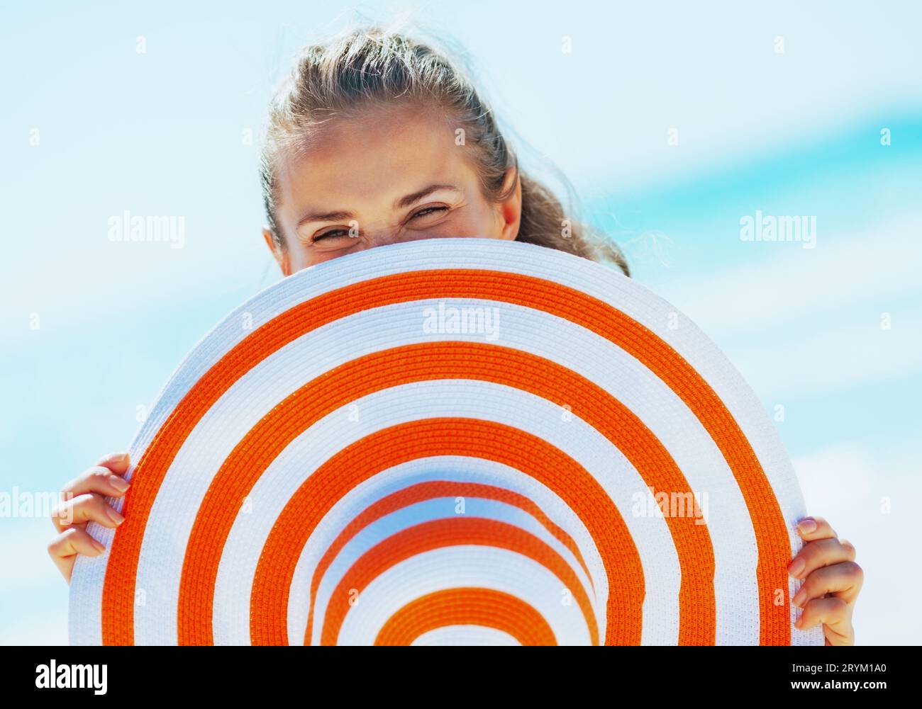 Woman cap hiding hi-res stock photography and images - Alamy