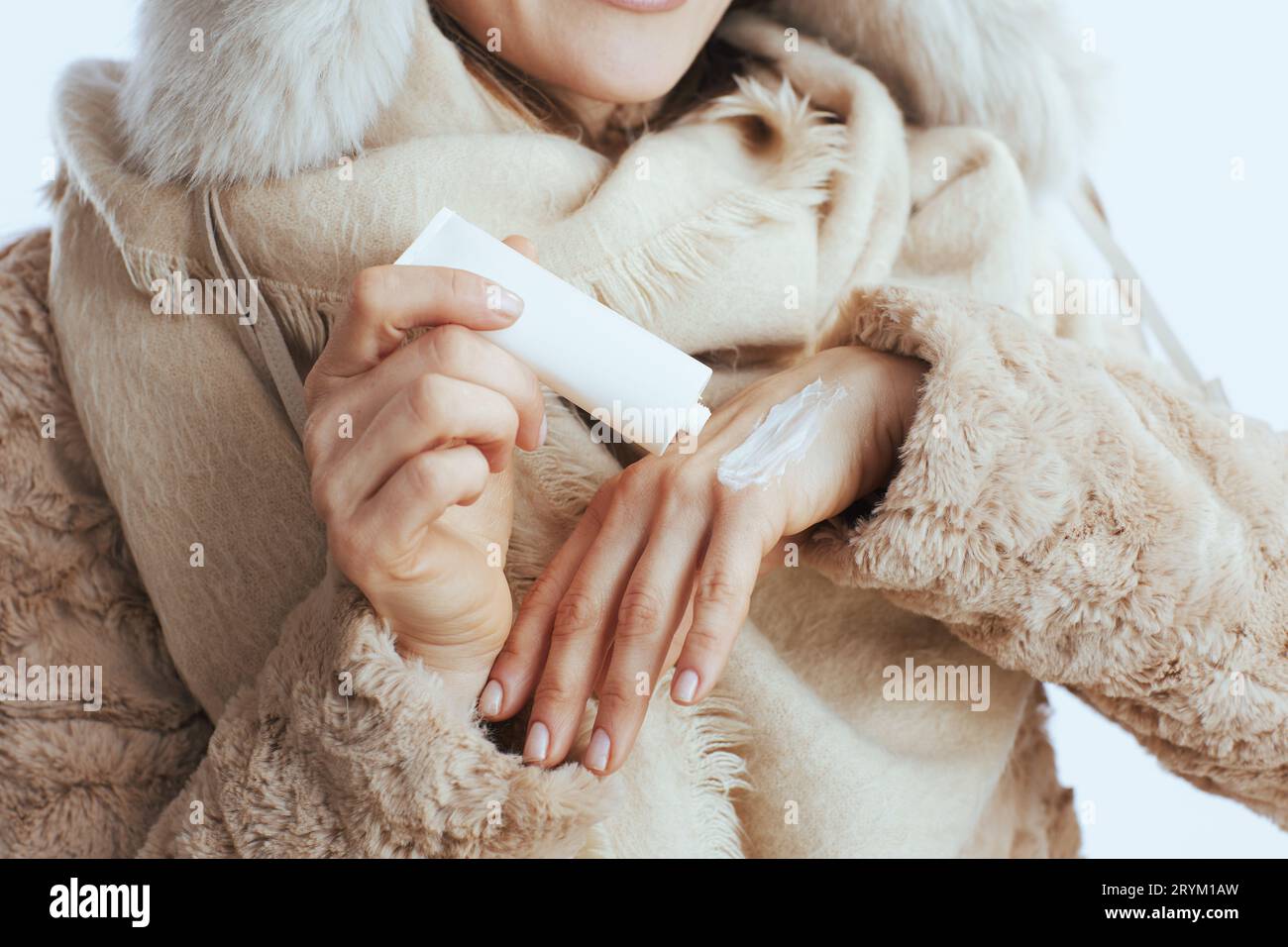 Closeup on woman against white background with hand cream Stock Photo ...