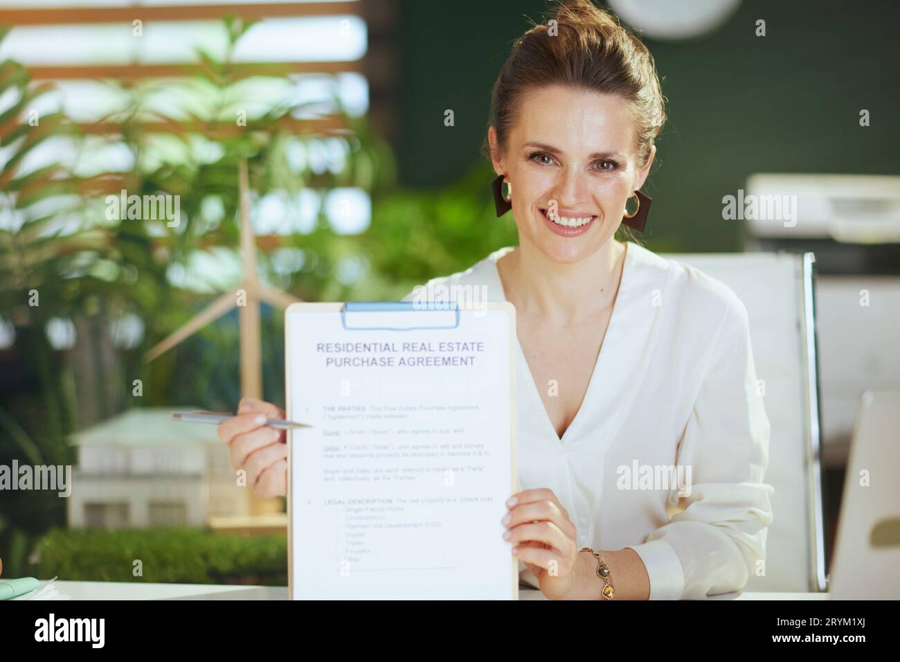 Sustainable real estate business. smiling elegant female realtor in ...