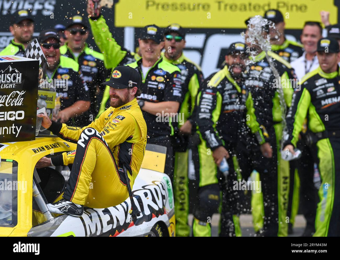 Ryan Blaney, front left, celebrates after winning a NASCAR Cup Series ...