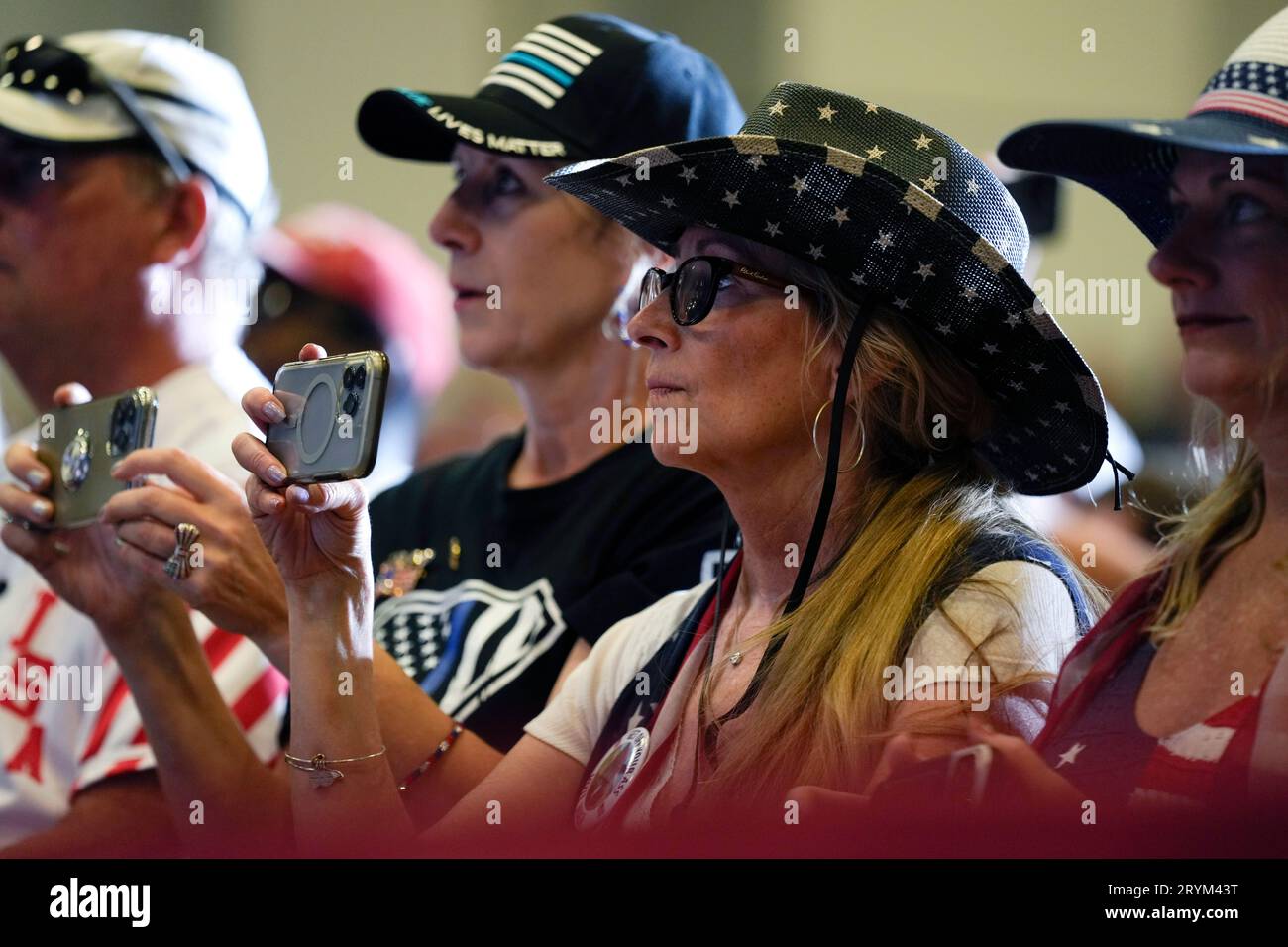 Supporters listen to former President Donald Trump speak during a ...