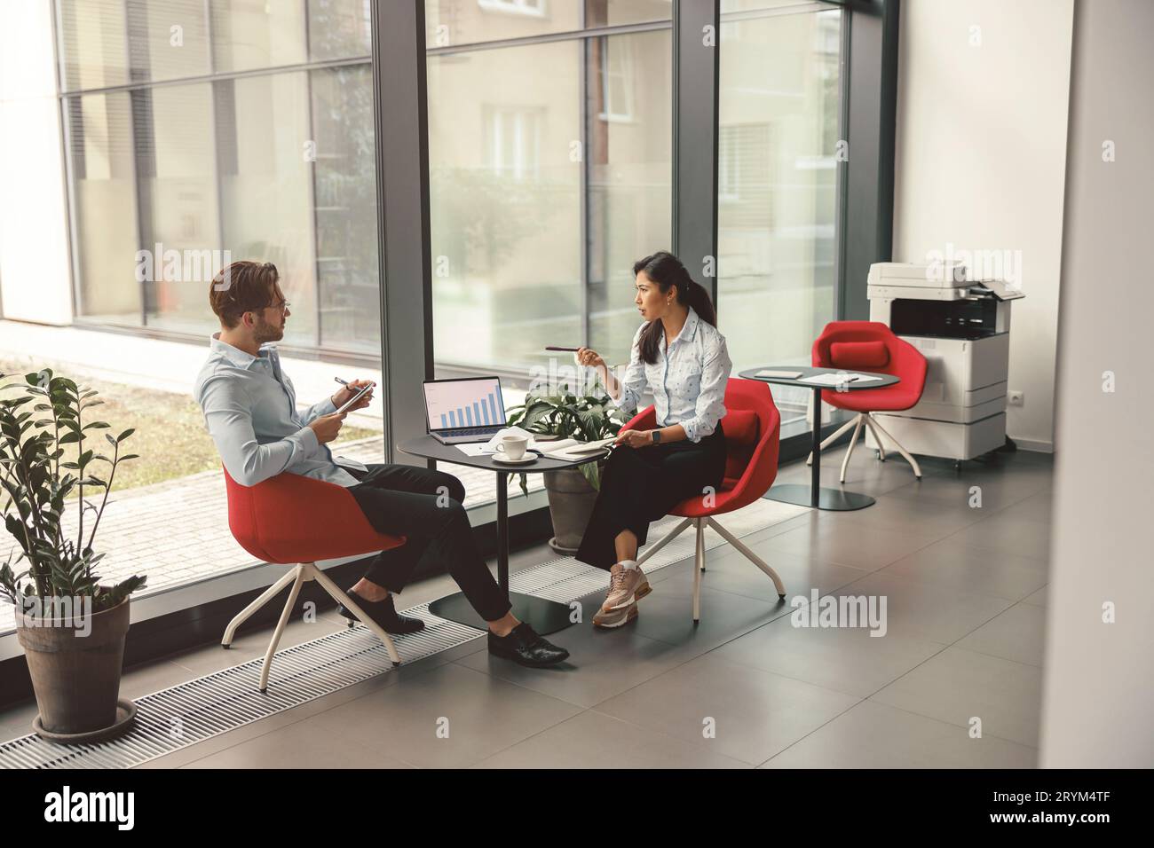 Two business colleagues analysts working with documents together ...