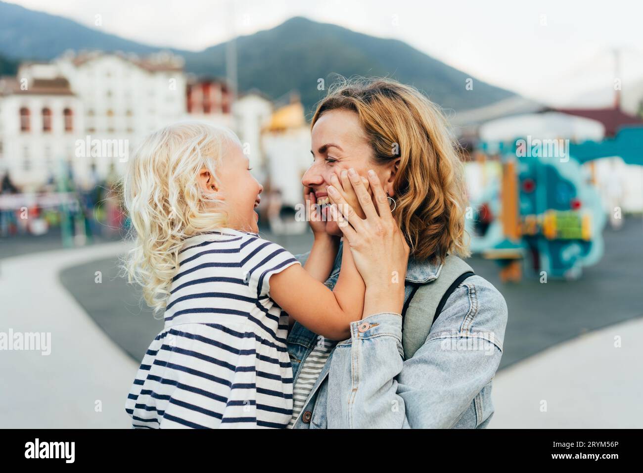 Gentle caring hugs of a mother with a little daughter outside. The ...