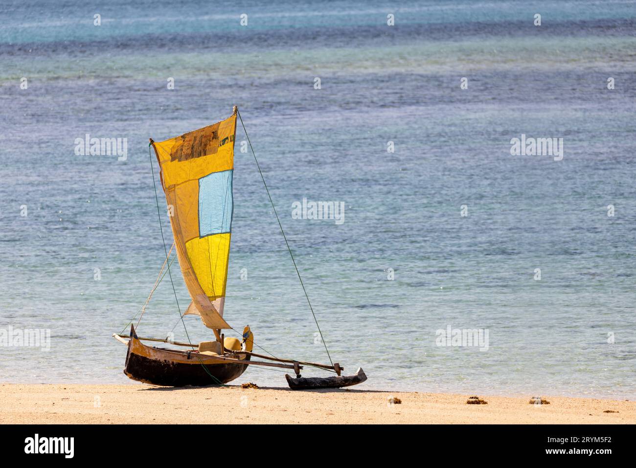 Tranquil scene of a wooden fishing boat resting on the golden sands of ...