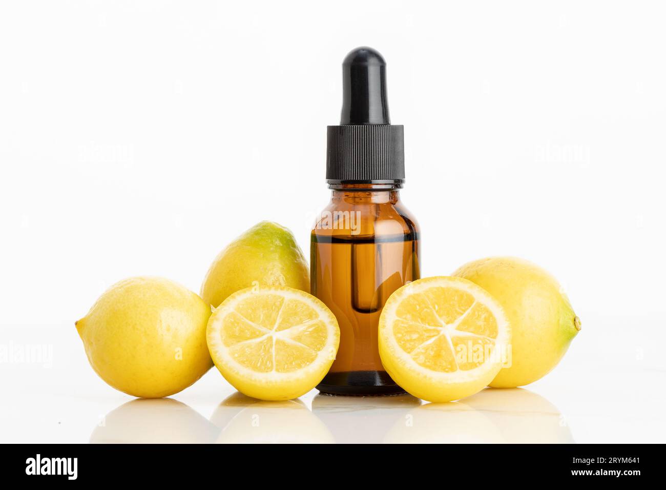 Lemon essential oil on white background. Citrus oil Stock Photo - Alamy