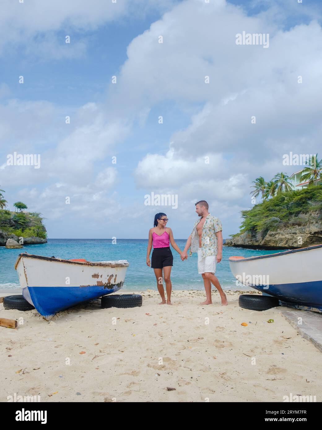 A couple of men and woman in swimshort and bikini at Playa Lagun Beach ...