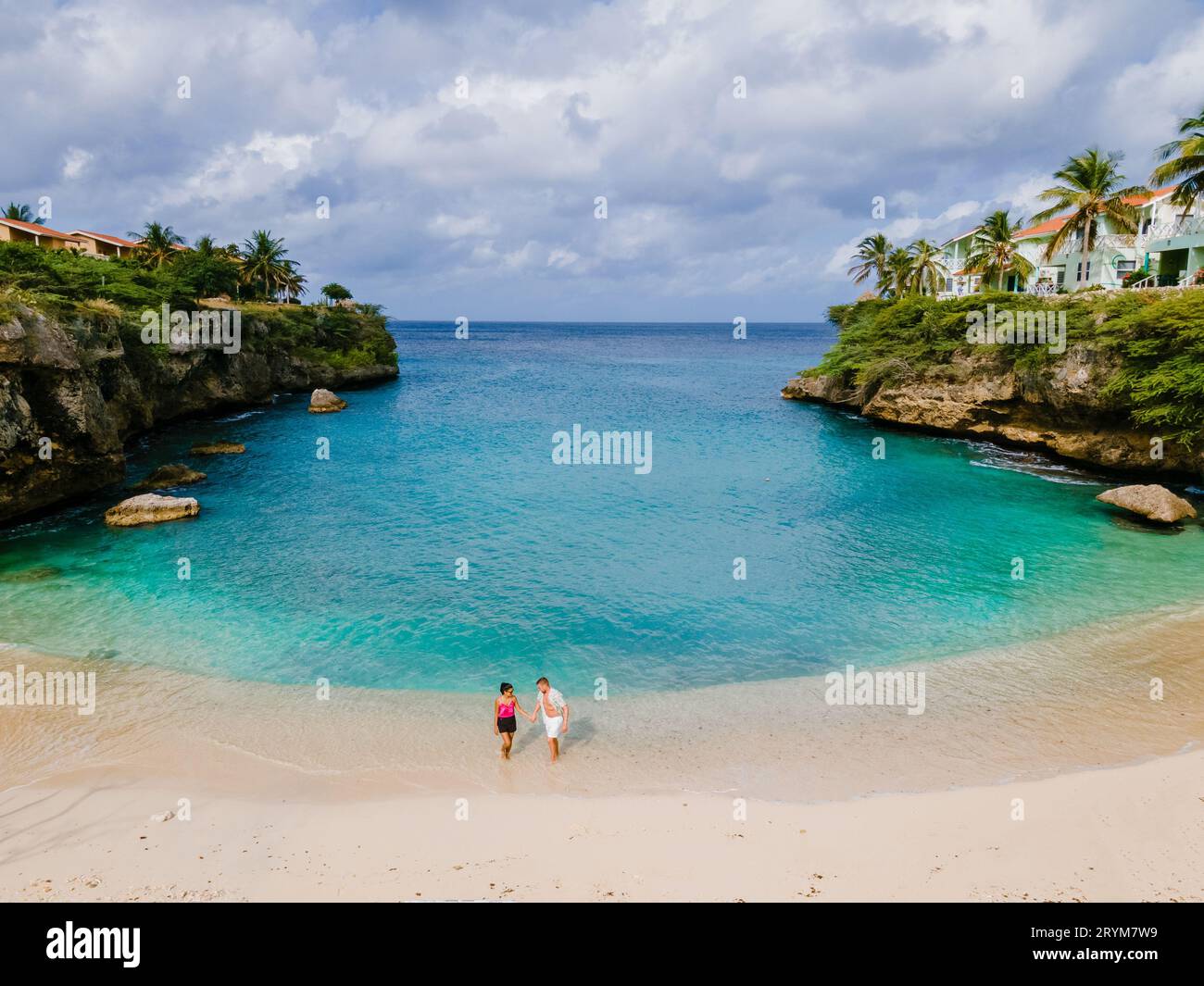 A couple of men and woman in swimshort and bikini at Playa Lagun Beach ...