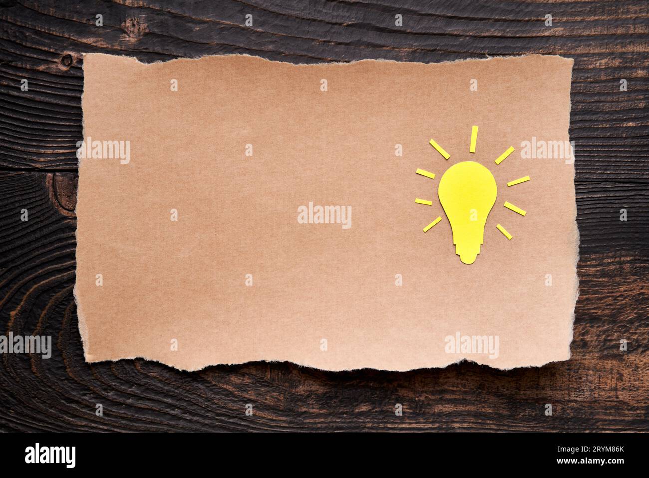 Creative idea and inspiration concept with paper light bulb on ripped ...
