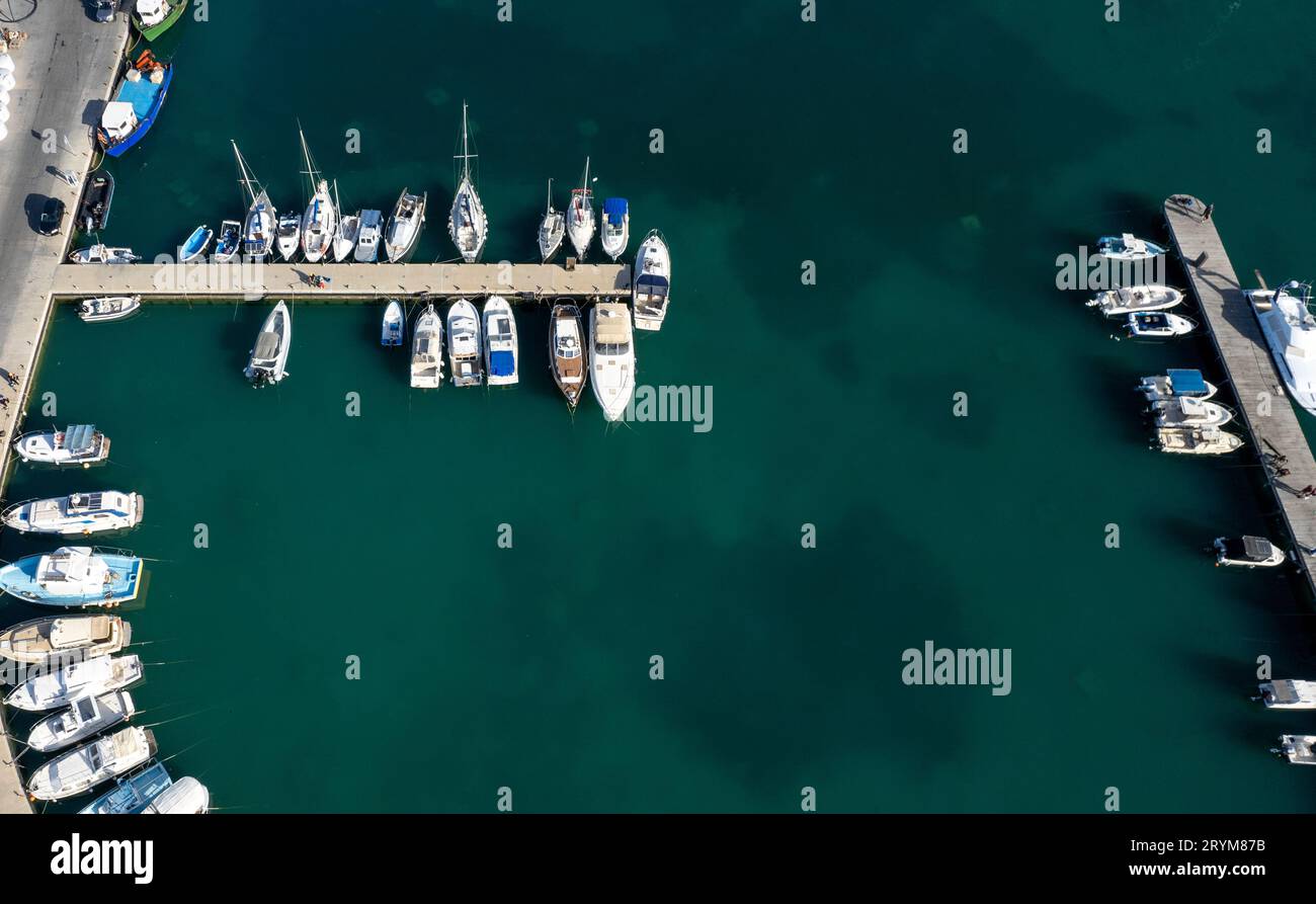 Drone aerial scenery of a fishing port. Fishing boats and yachts moored ...