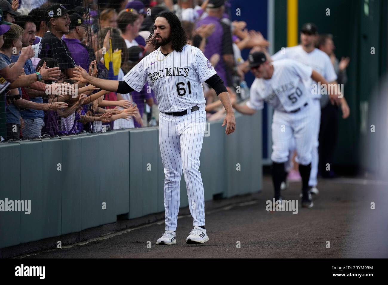 Colorado Rockies relief pitcher Justin Lawrence, front right, greets ...