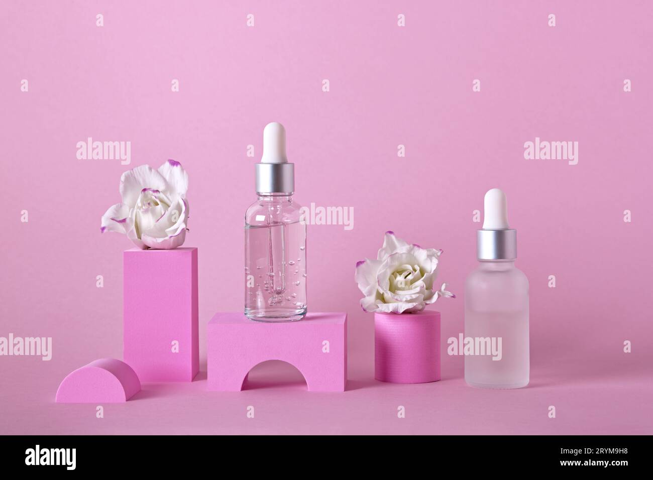 Beauty skincare product mock up. Serum bottles and flowers on different ...