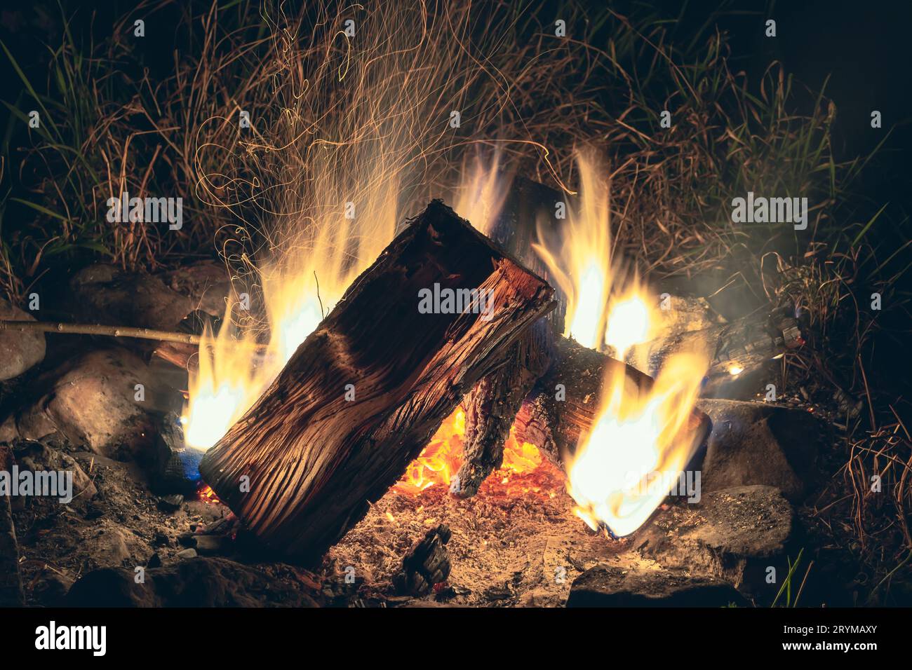 Bright night bonfire among grass and stones. Beautiful bonfire with ...