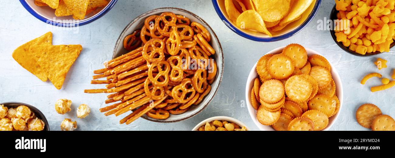 Salty snacks, party mix panorama. An assortment of crispy appetizers ...