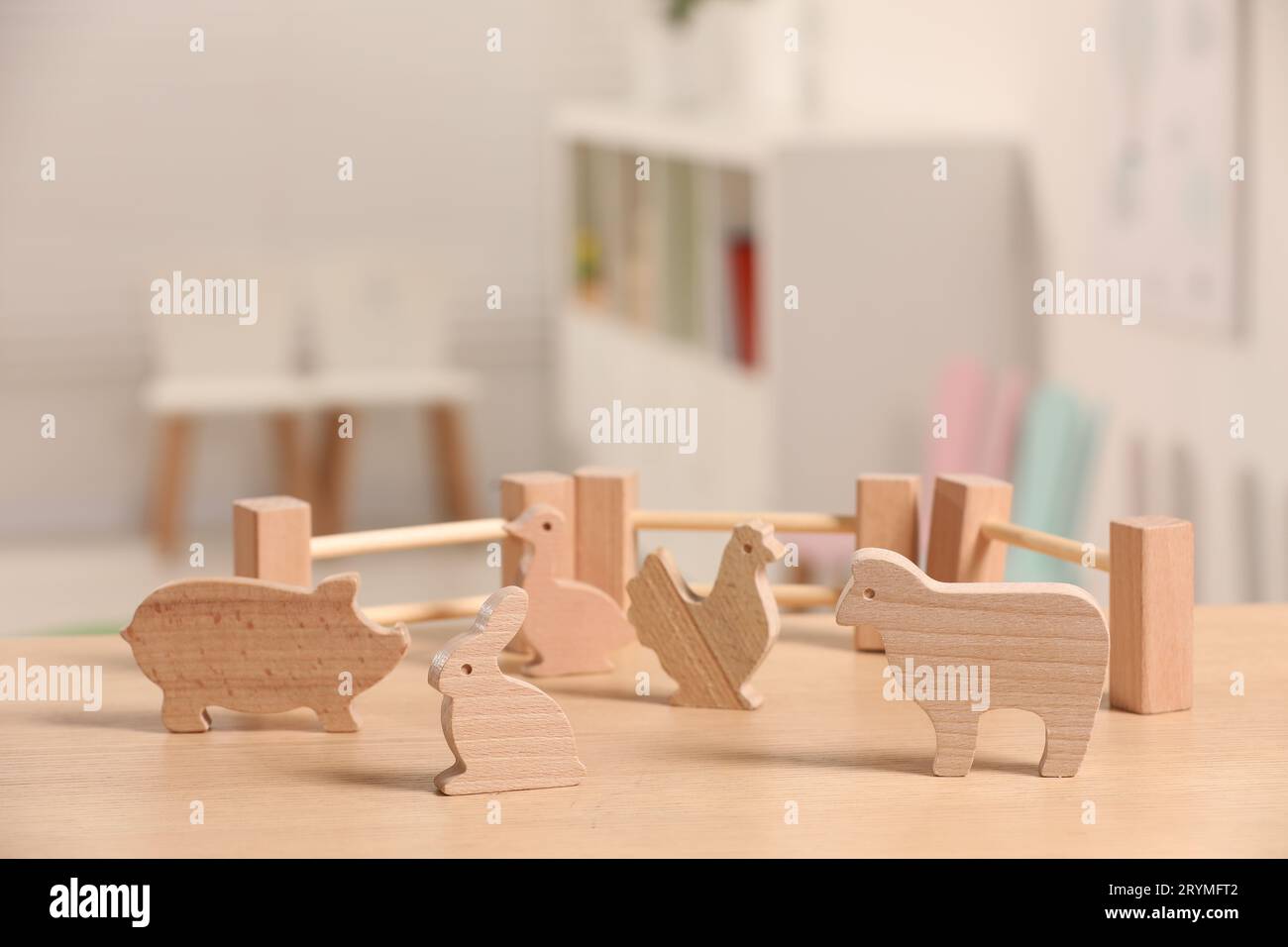 Wooden animals and fence on table indoors. Children's toys Stock Photo ...