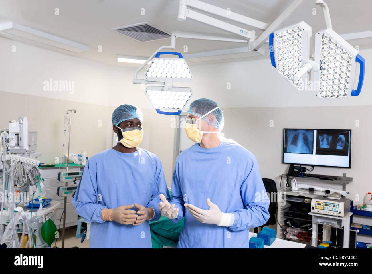 Two diverse male surgeons discussing before operation in operating ...