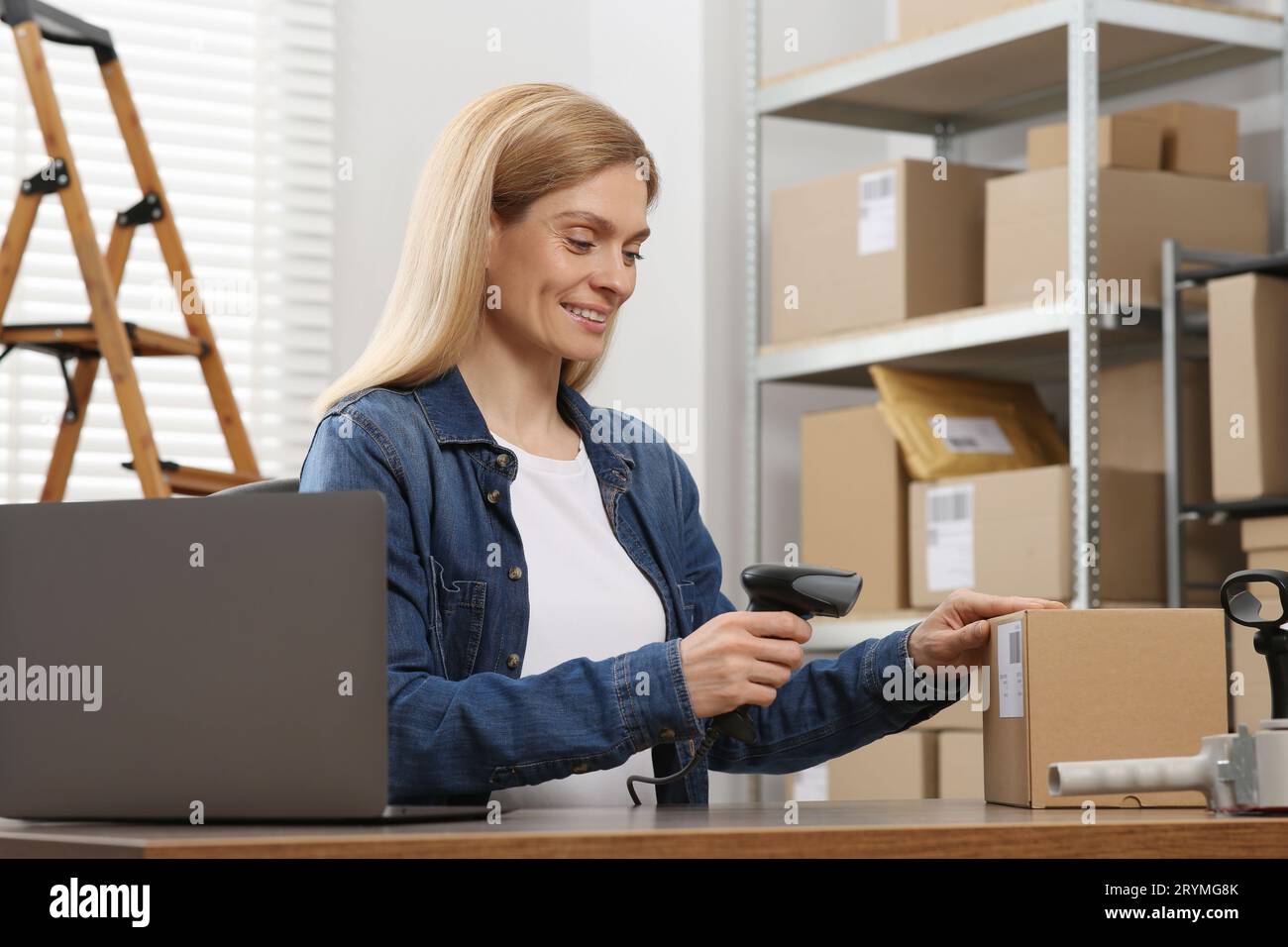 Woman scanner reading parcel hi-res stock photography and images - Alamy