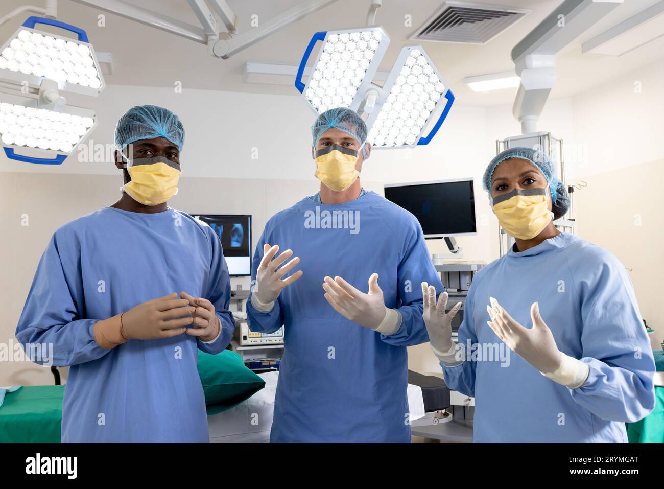 Portrait of three diverse male and female surgeons before operation in ...