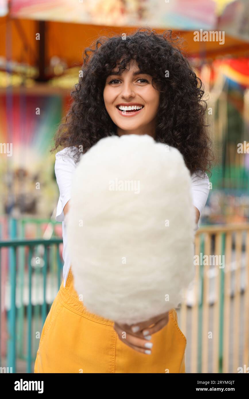 Girl holding cotton candy smiling hi-res stock photography and images ...