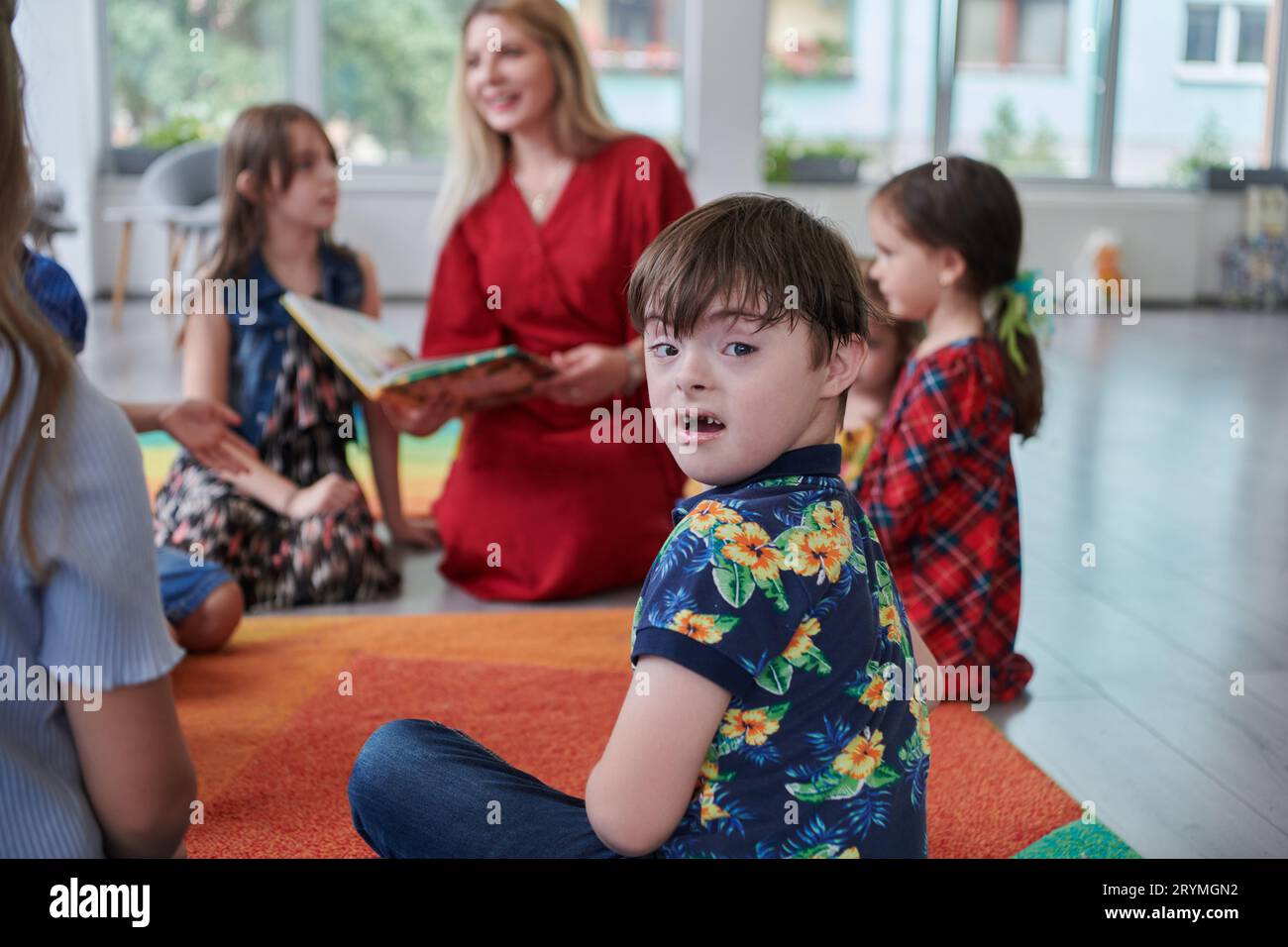 Reading time in an elementary school or kindergarten, a teacher reading ...