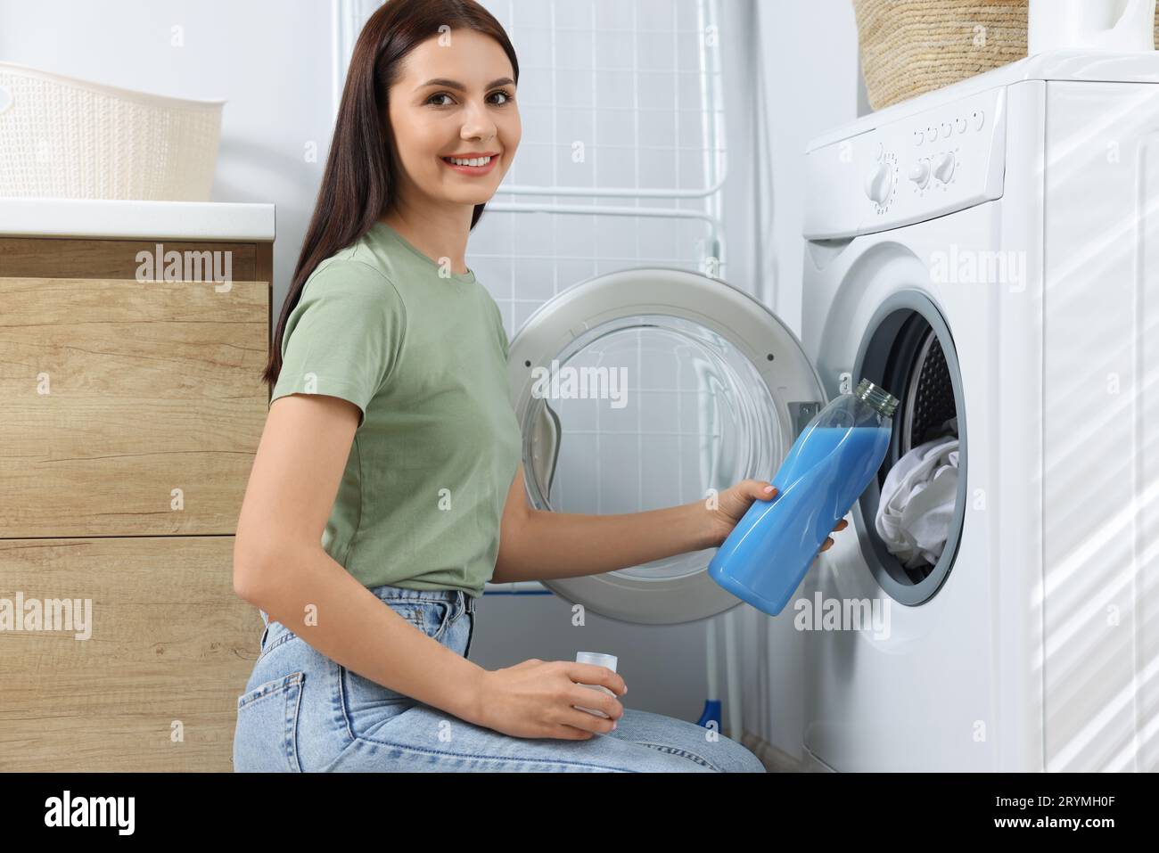 Woman pouring fabric softener washing hi-res stock photography and ...