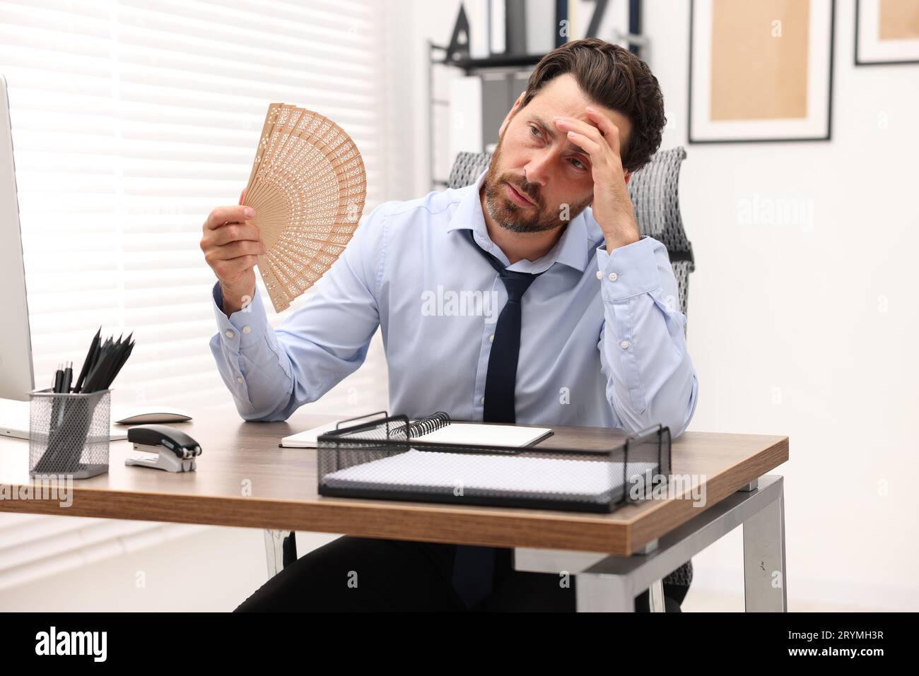 Man in office fanning hi-res stock photography and images - Alamy