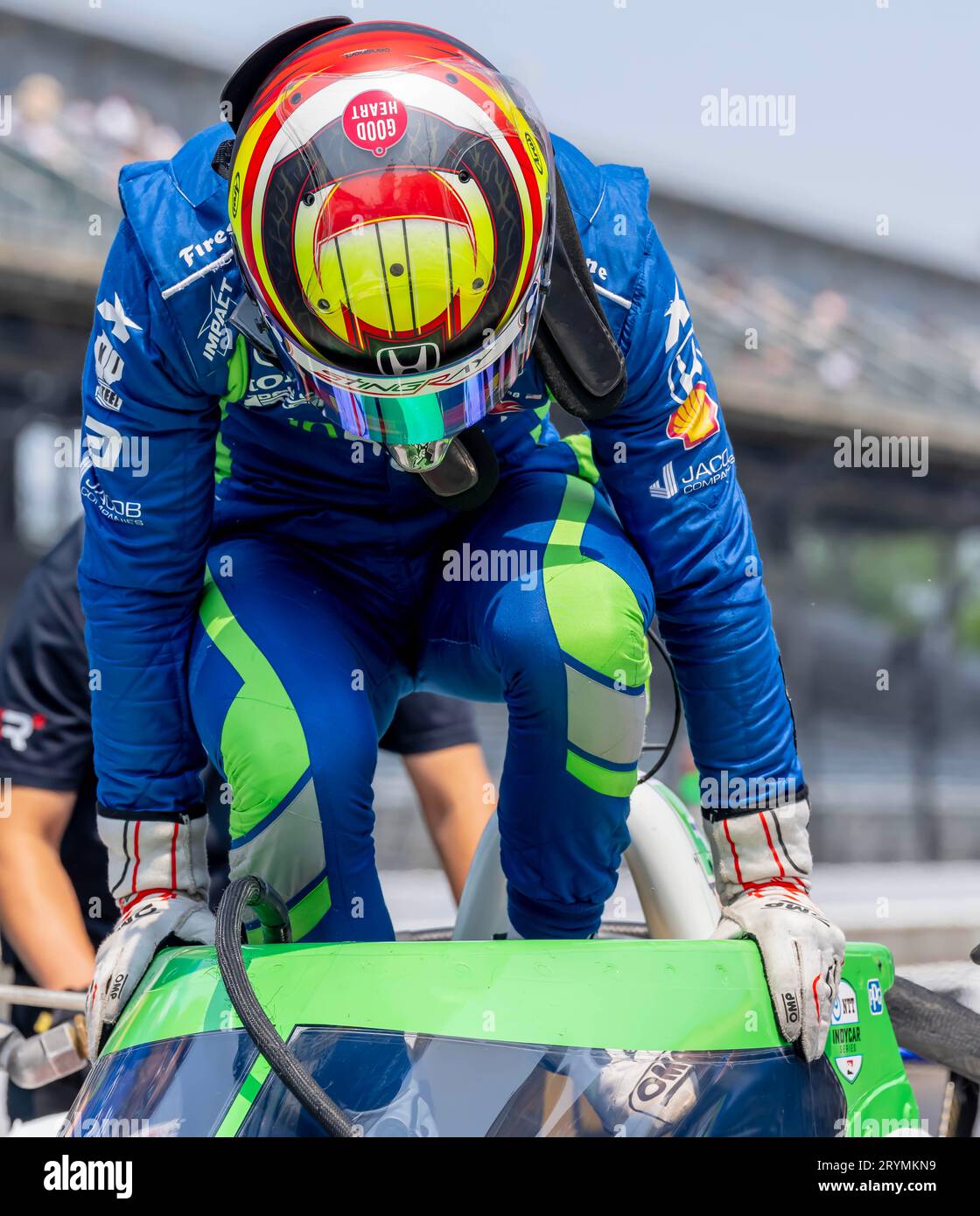 INDYCAR driver, STING RAY ROBB (R) (51) of Payette, Idaho, straps into ...