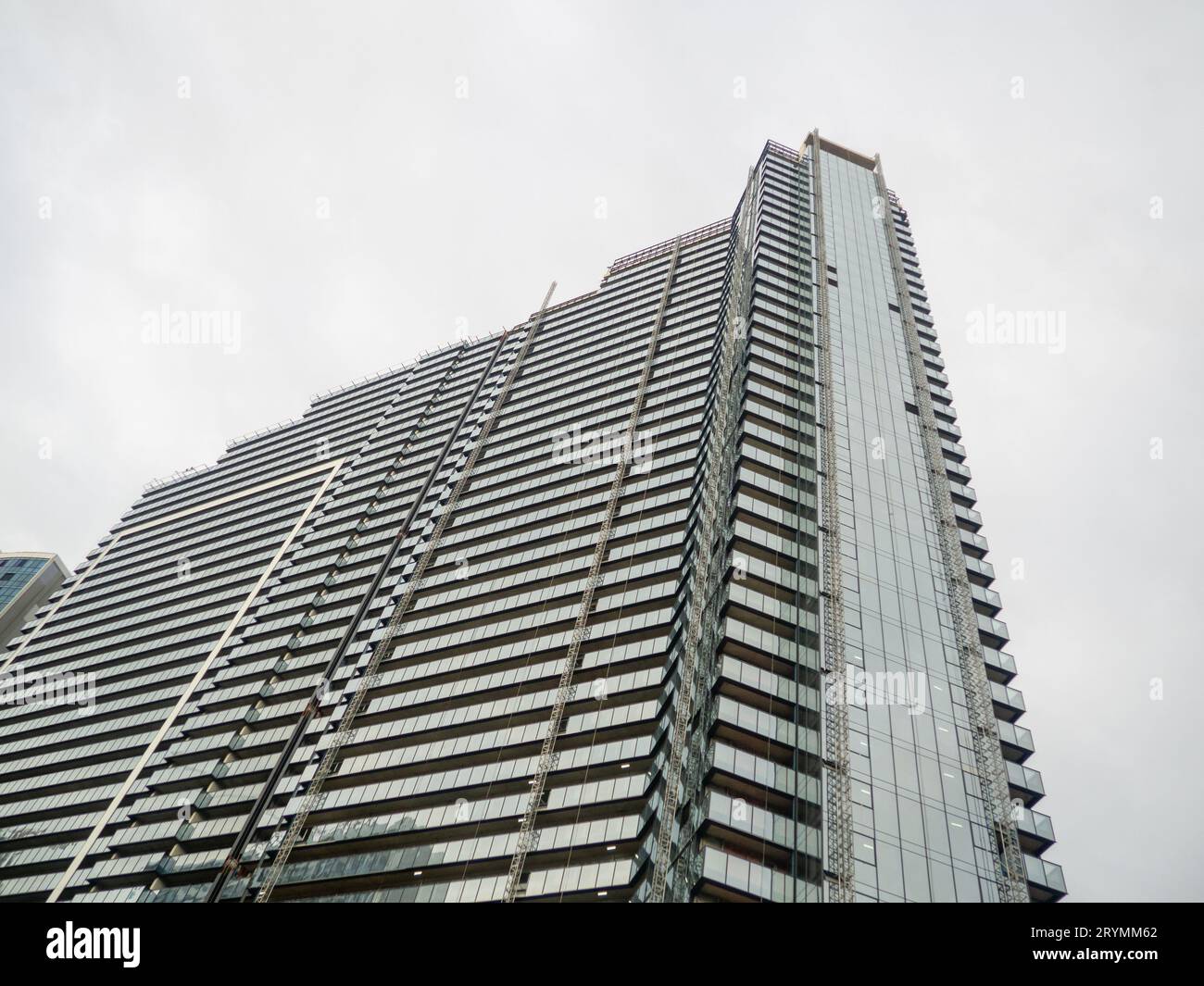 Construction of a high-rise building. Skyscraper glazing. Scaffolding ...
