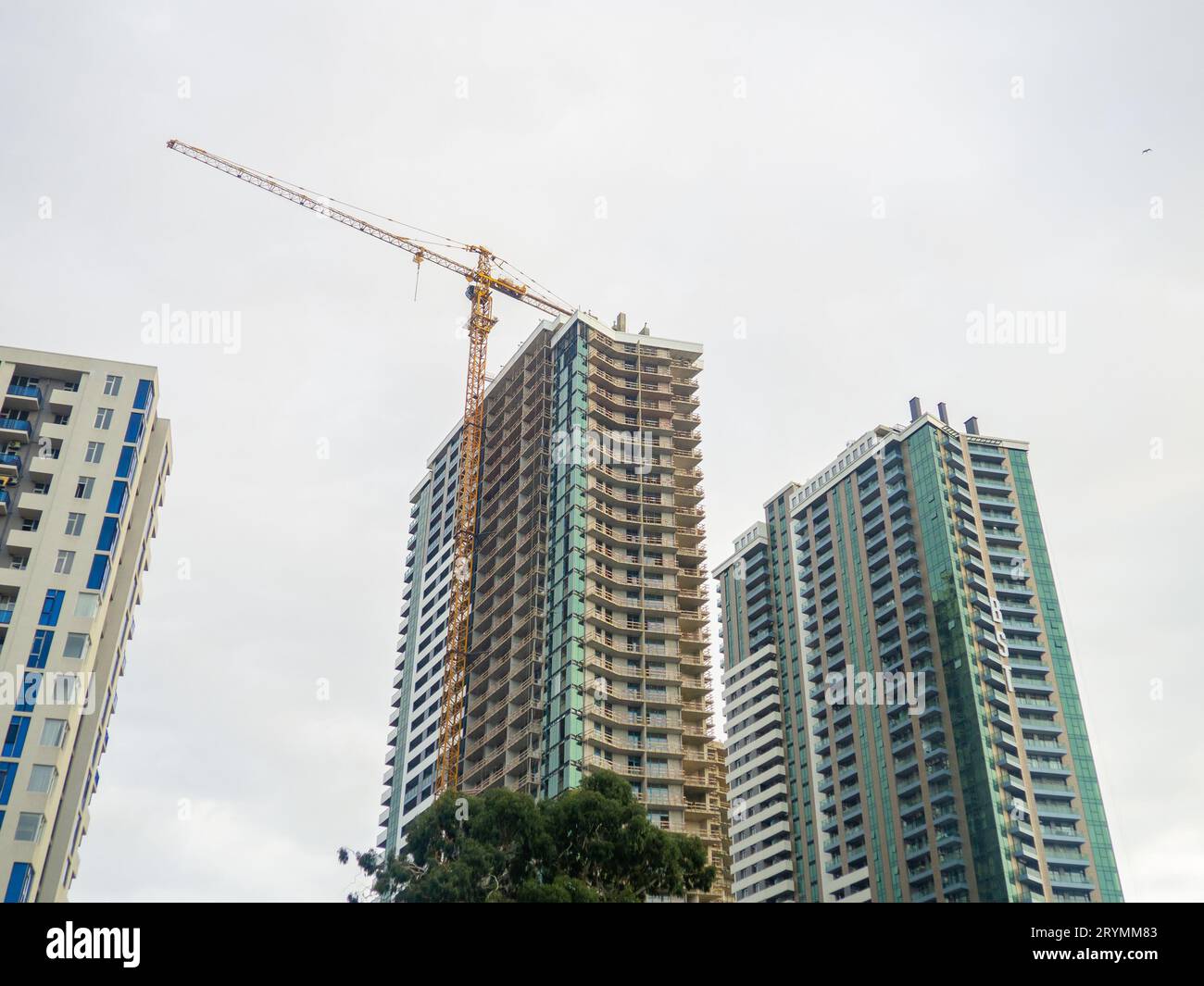 Construction of a high-rise building. Skyscraper glazing. Scaffolding ...