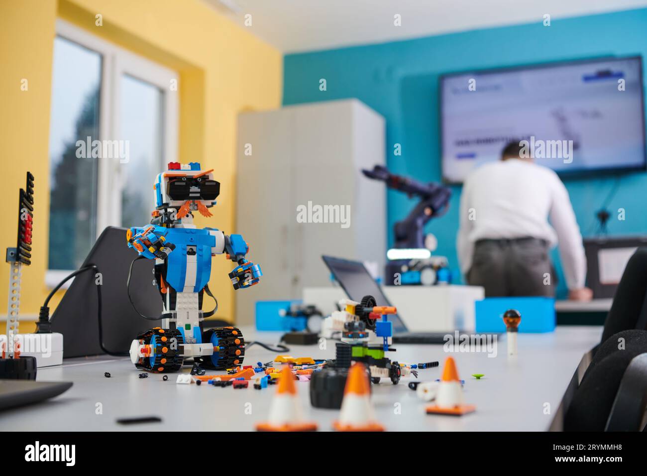 A student testing his new invention of a robotic arm in the laboratory ...