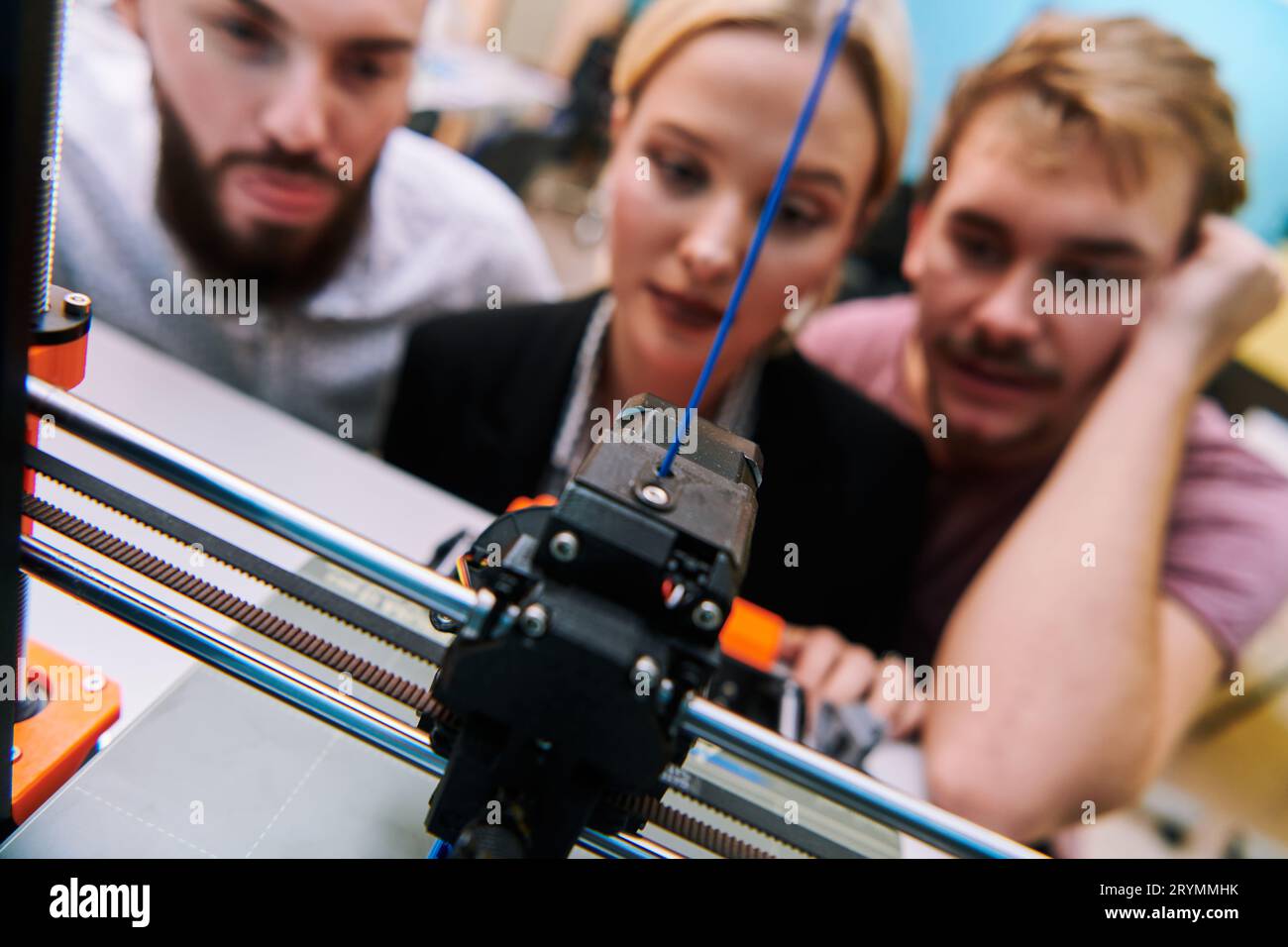A group of colleagues working together in a robotics laboratory ...