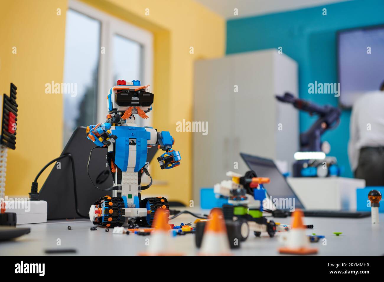 A student testing his new invention of a robotic arm in the laboratory ...