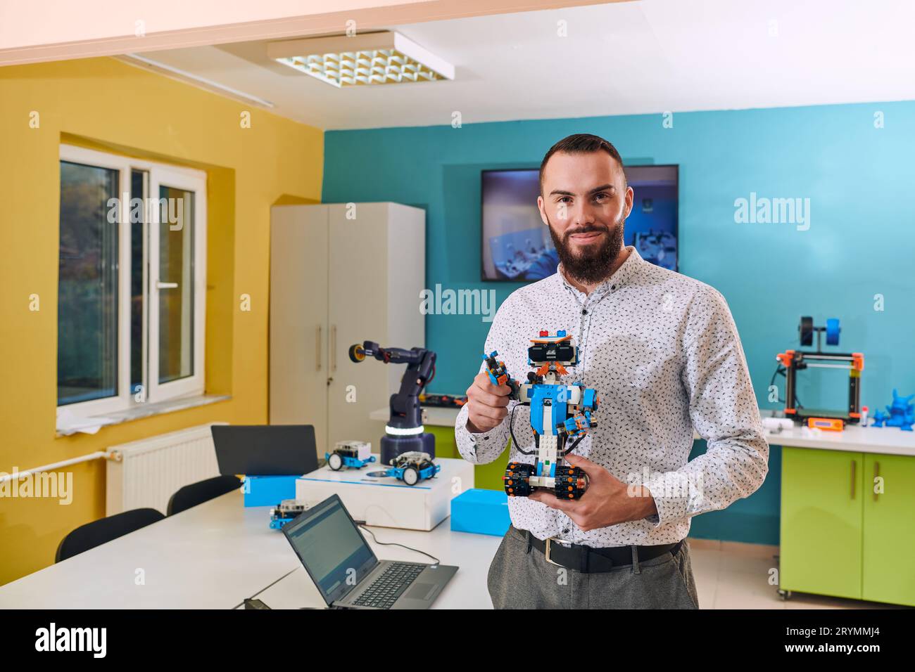 A Man Working In A Robotics Laboratory Focusing On The Intricate Fields Of Robotics And 3d