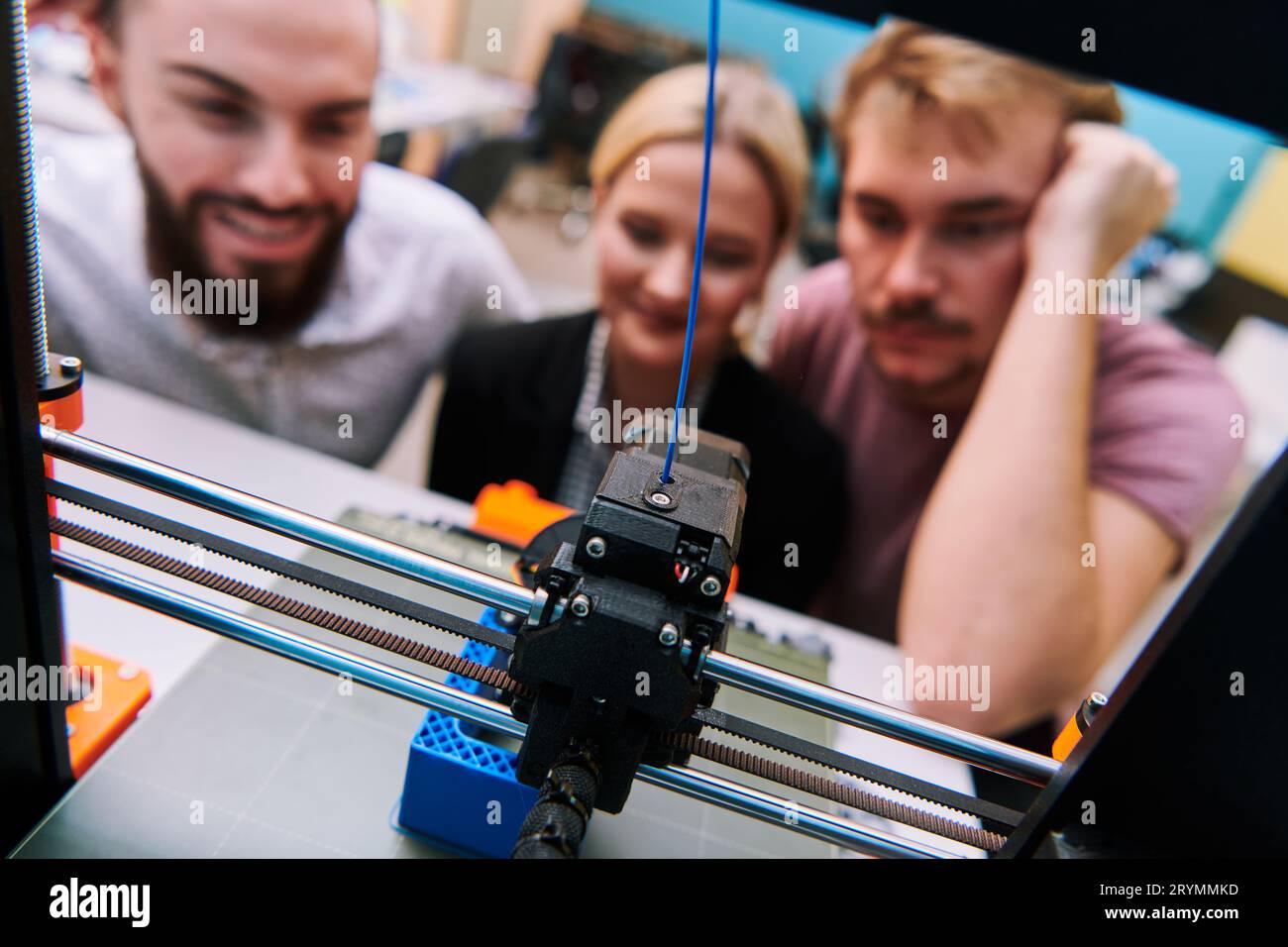 A group of colleagues working together in a robotics laboratory ...