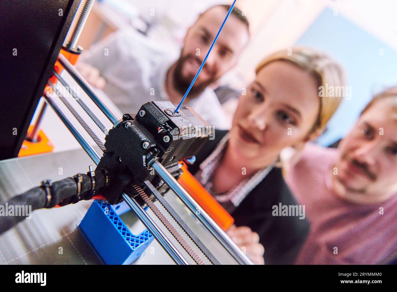 A group of colleagues working together in a robotics laboratory ...