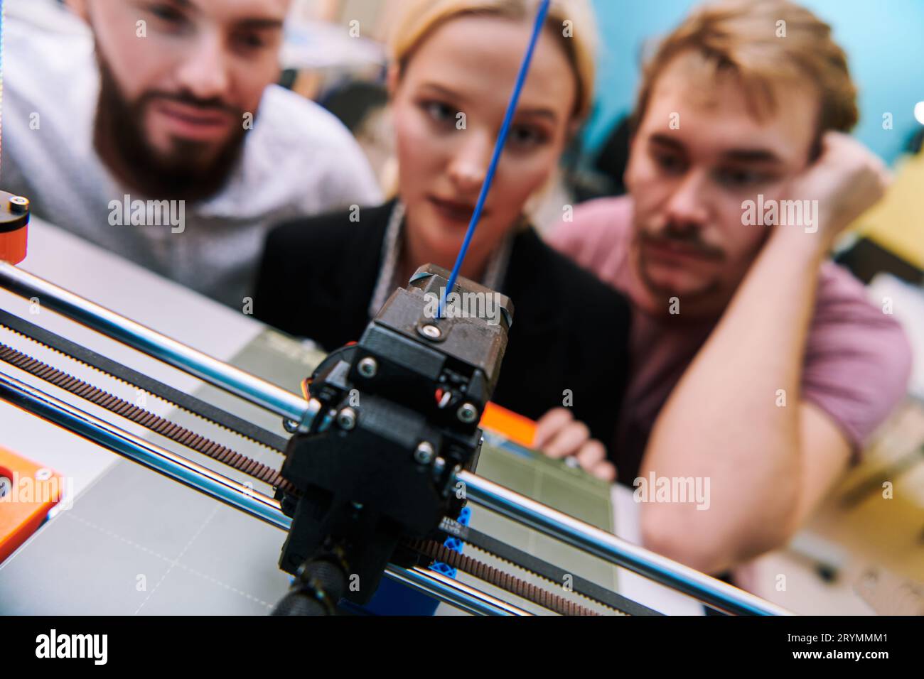A group of colleagues working together in a robotics laboratory ...