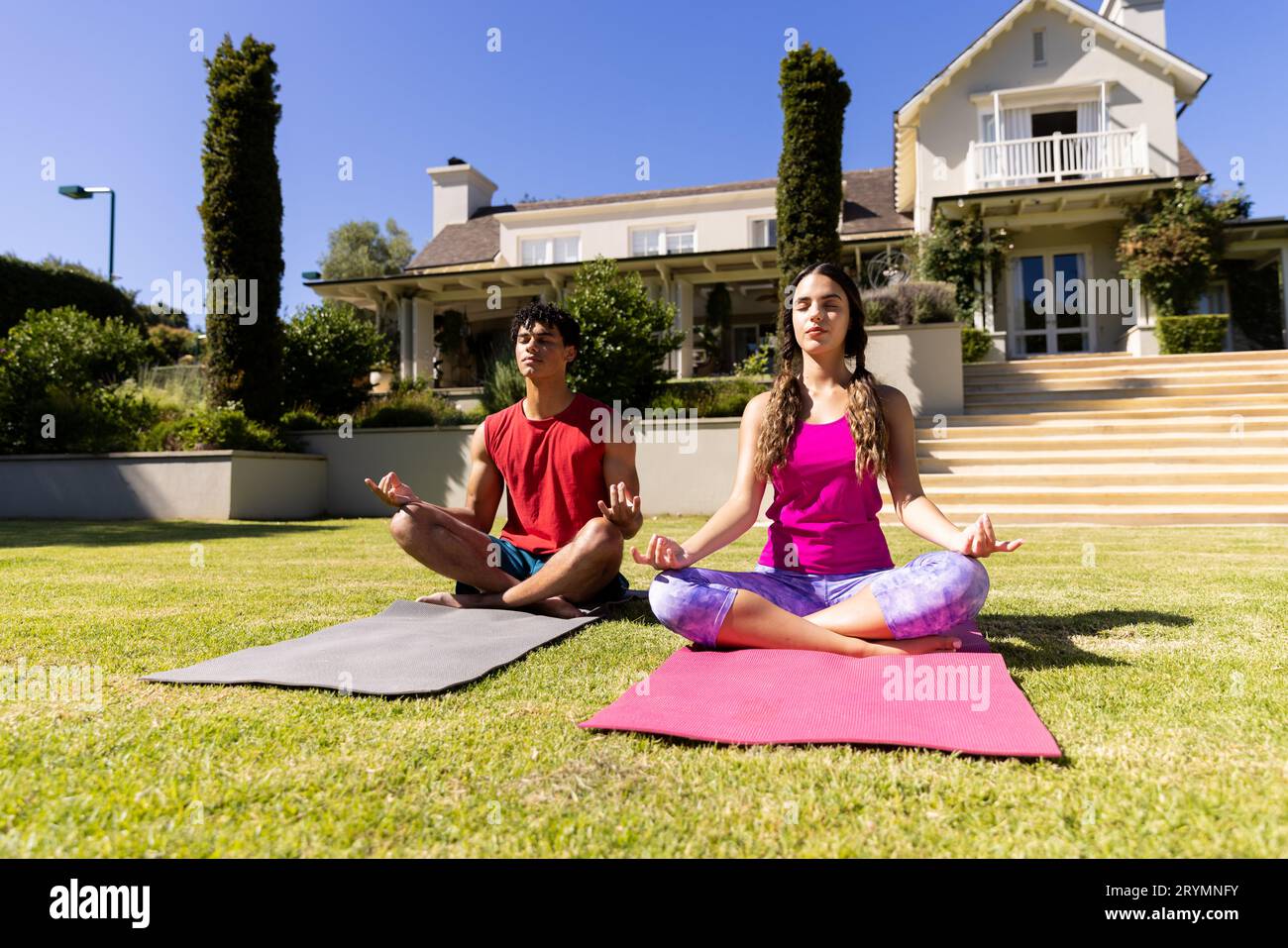 Happy diverse couple practicing yoga hi-res stock photography and ...