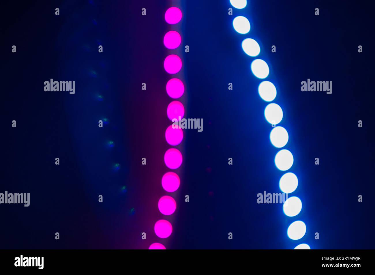 Pink and blue blurry neon bokeh lights on black. Abstract background of ...
